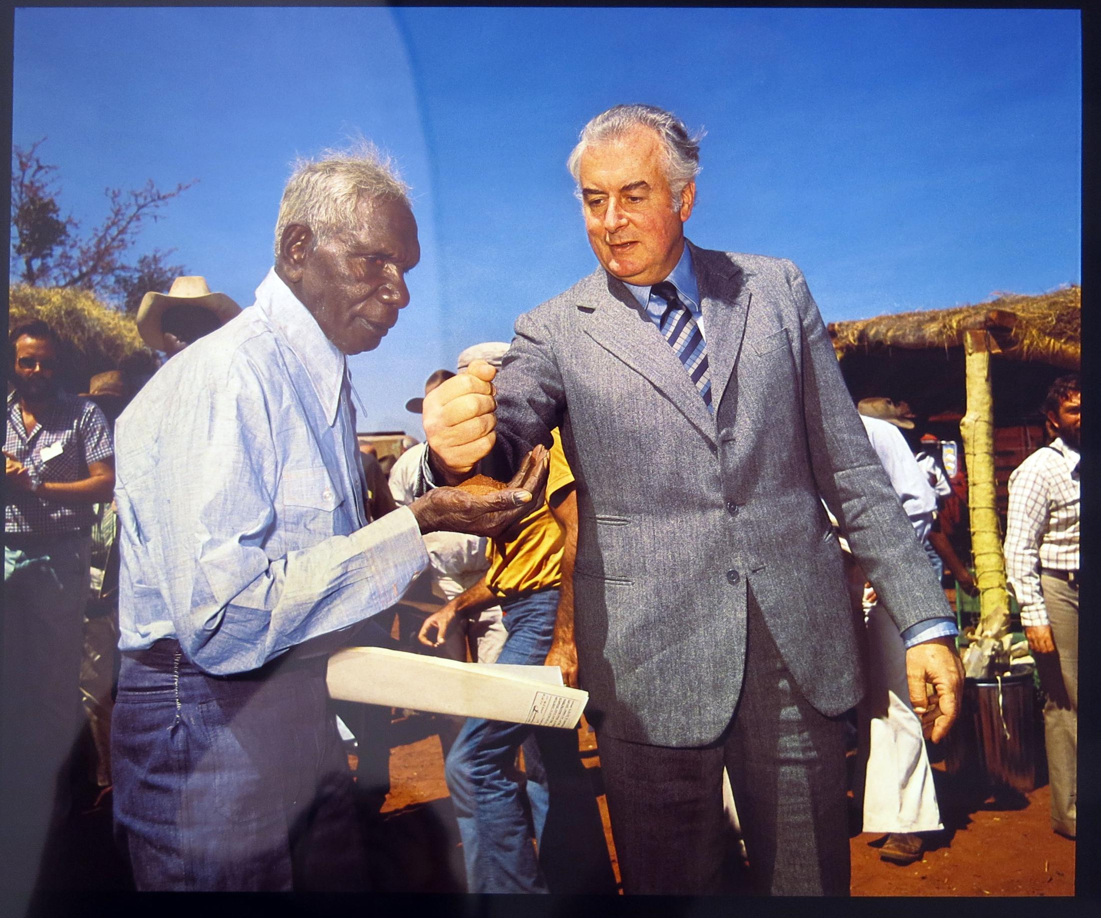 Mervyn Bishop, Prime Minister Gough Whitlam pours soil into the hands ...